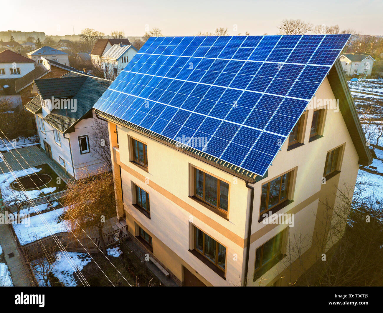Aerial view of new modern two story house cottage with blue shiny solar ...