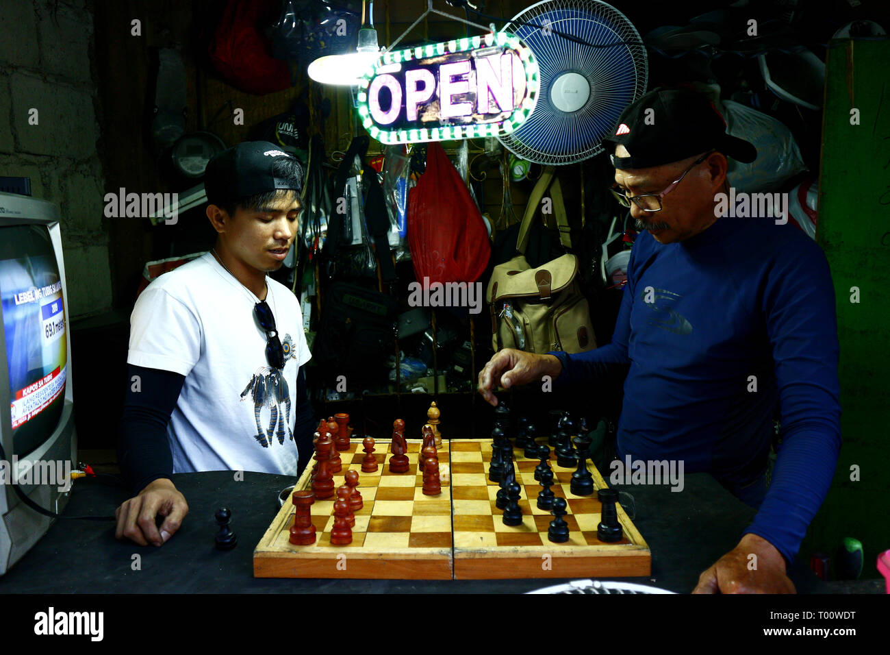 ANTIPOLO CITY, PHILIPPINES - MARCH 9, 2019: Filipino men relax and play ...