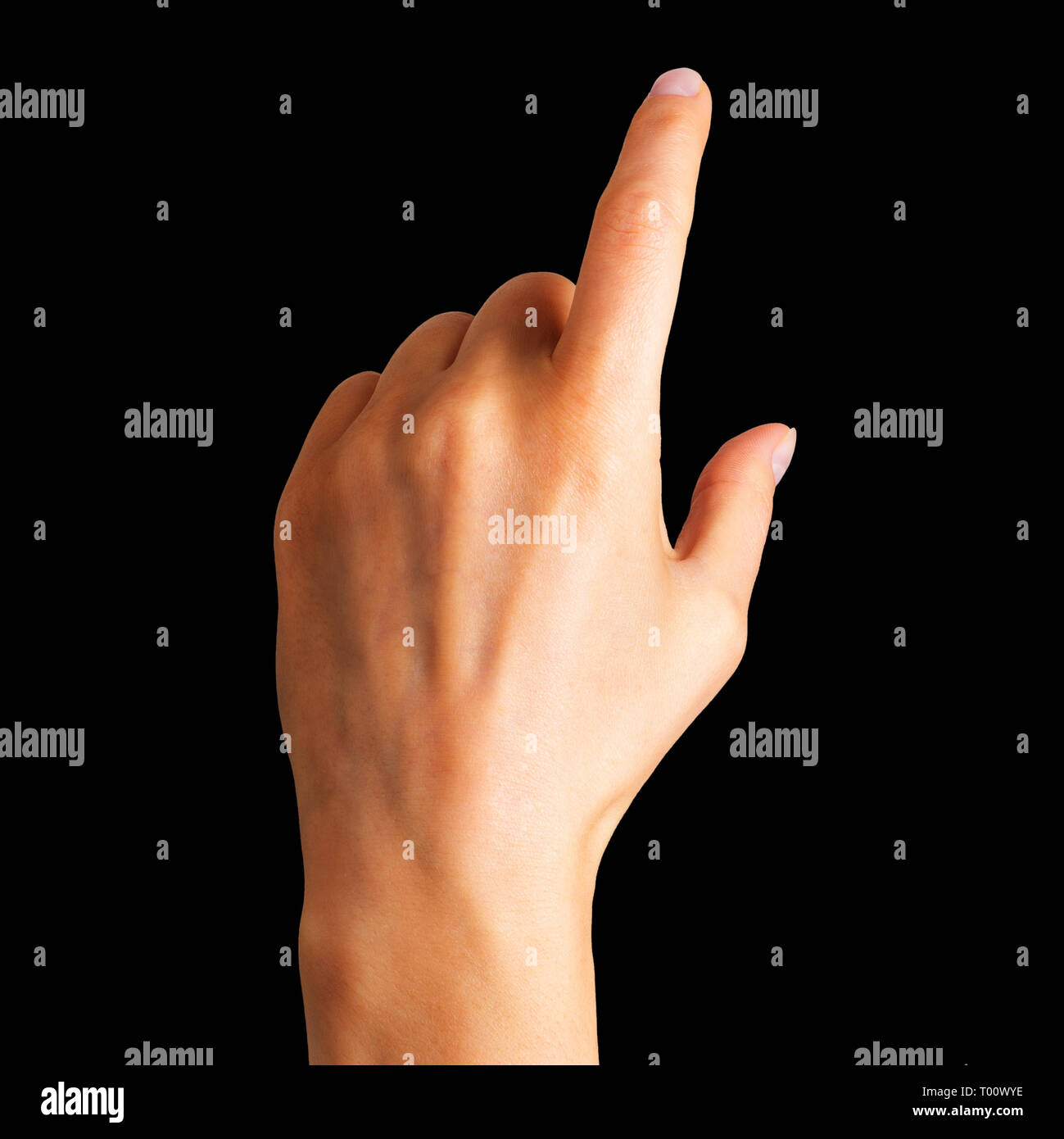 Woman hand with the index finger pointing up on black background ...