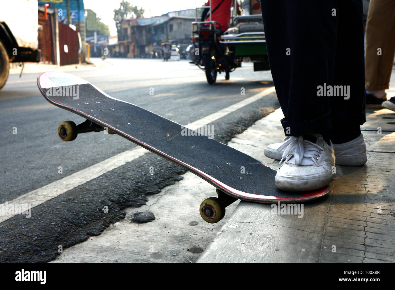 Photo of a foot of a skateboard rider stepping on a skateboard while on ...