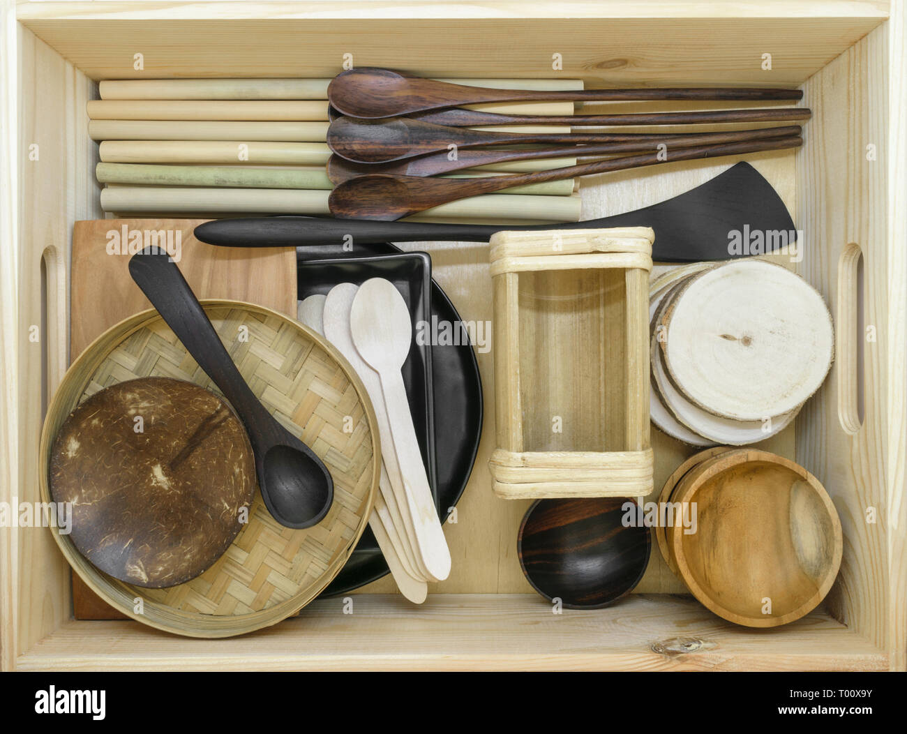 Set of various exotic wooden tableware in wooden box. Set consists ...