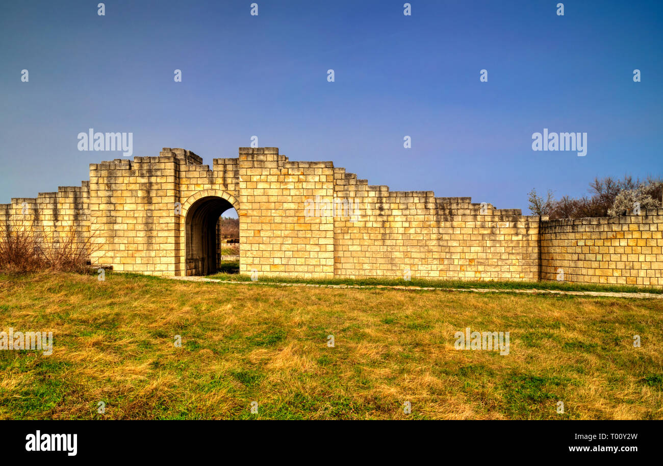 Solid stone wall and entrance of ancient fortress Stock Photo - Alamy