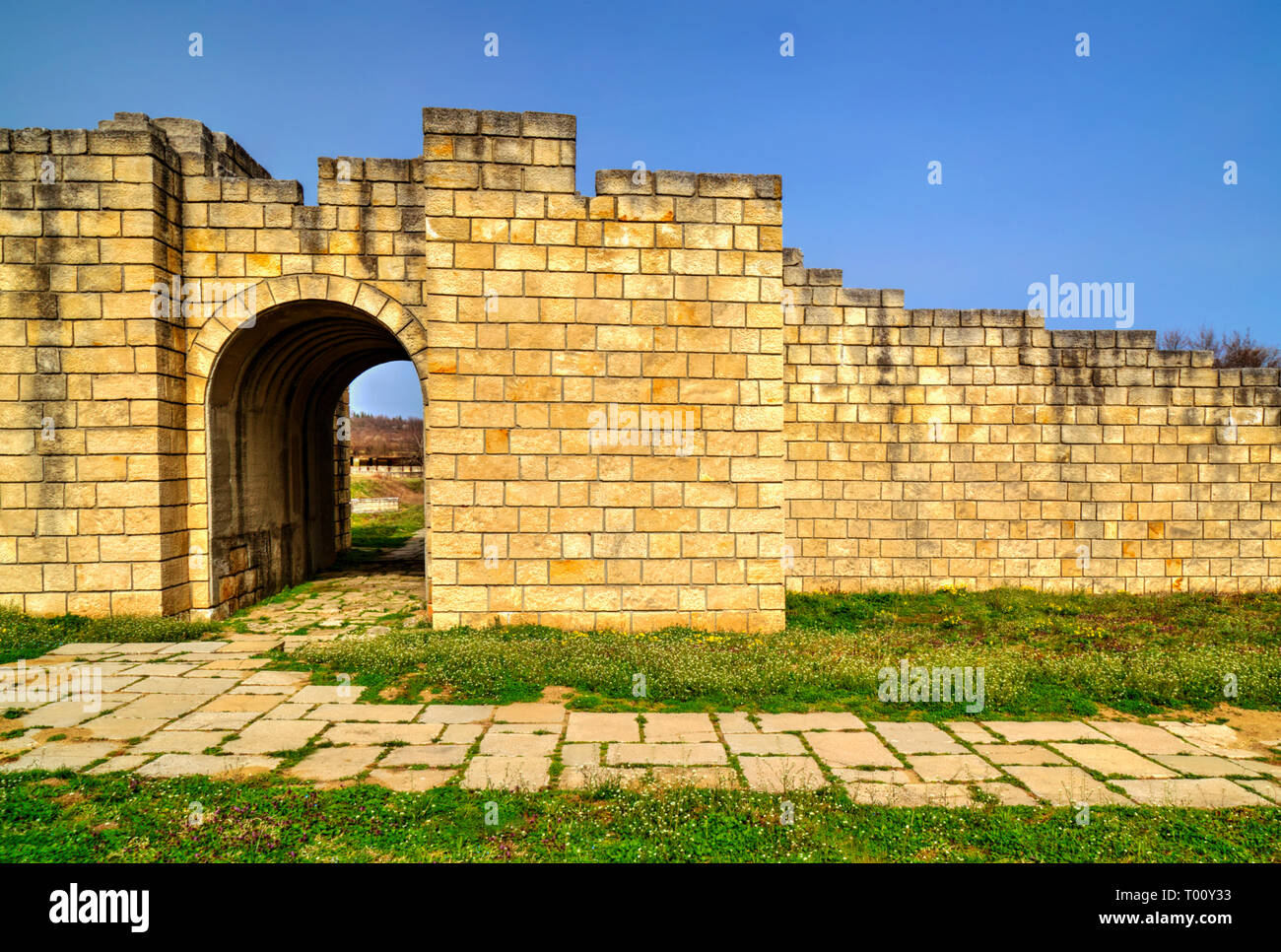 Solid stone wall and entrance of ancient fortress Stock Photo - Alamy