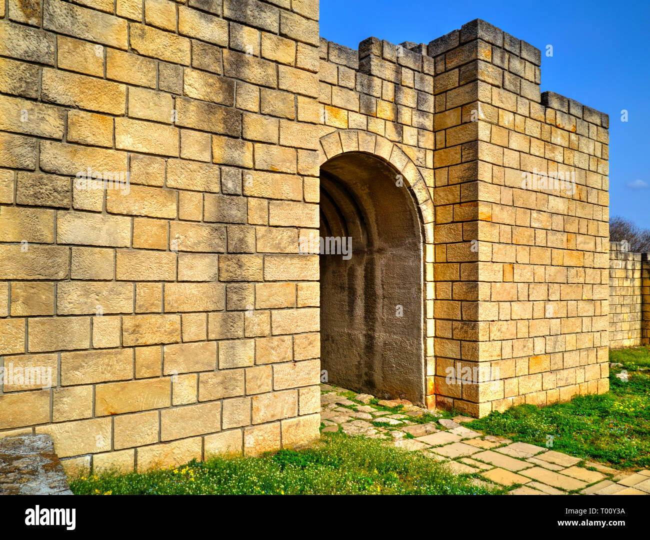 Solid stone wall and entrance of ancient fortress Stock Photo - Alamy