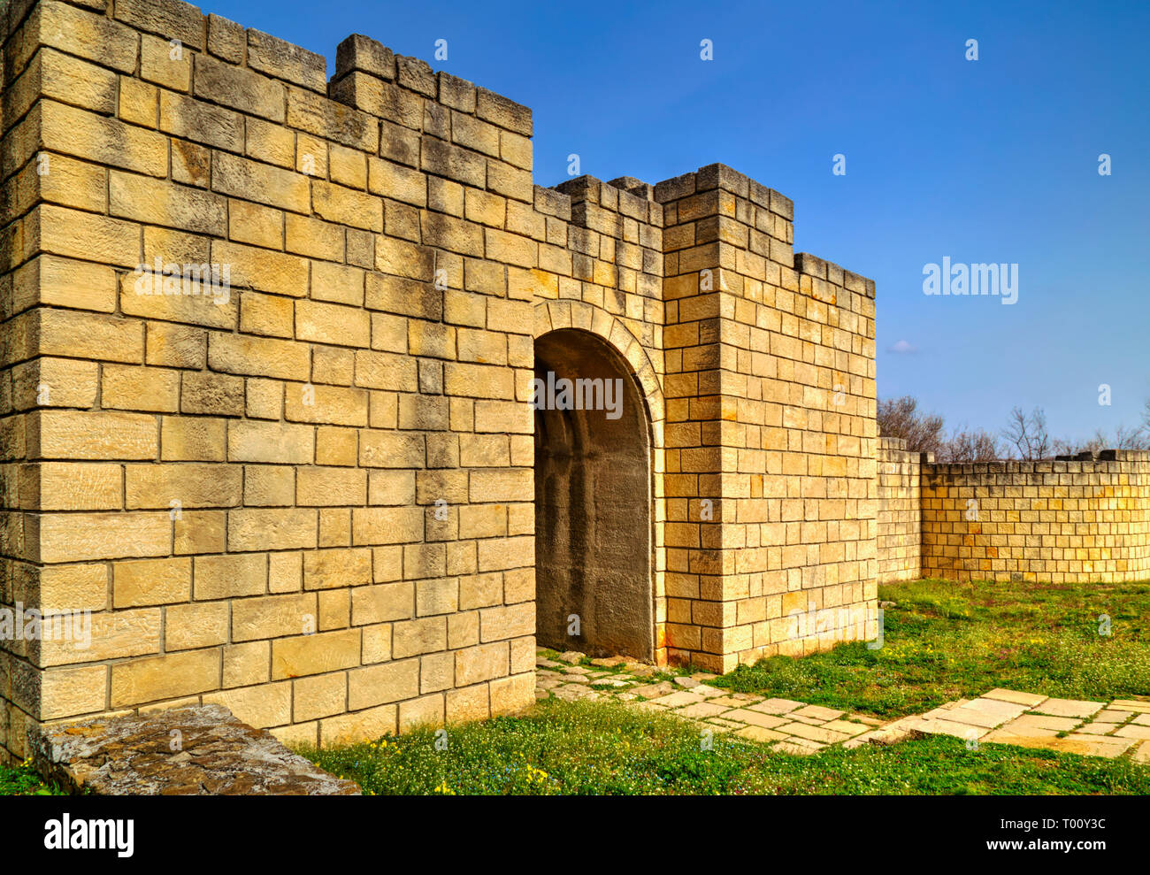 Solid stone wall and entrance of ancient fortress Stock Photo - Alamy