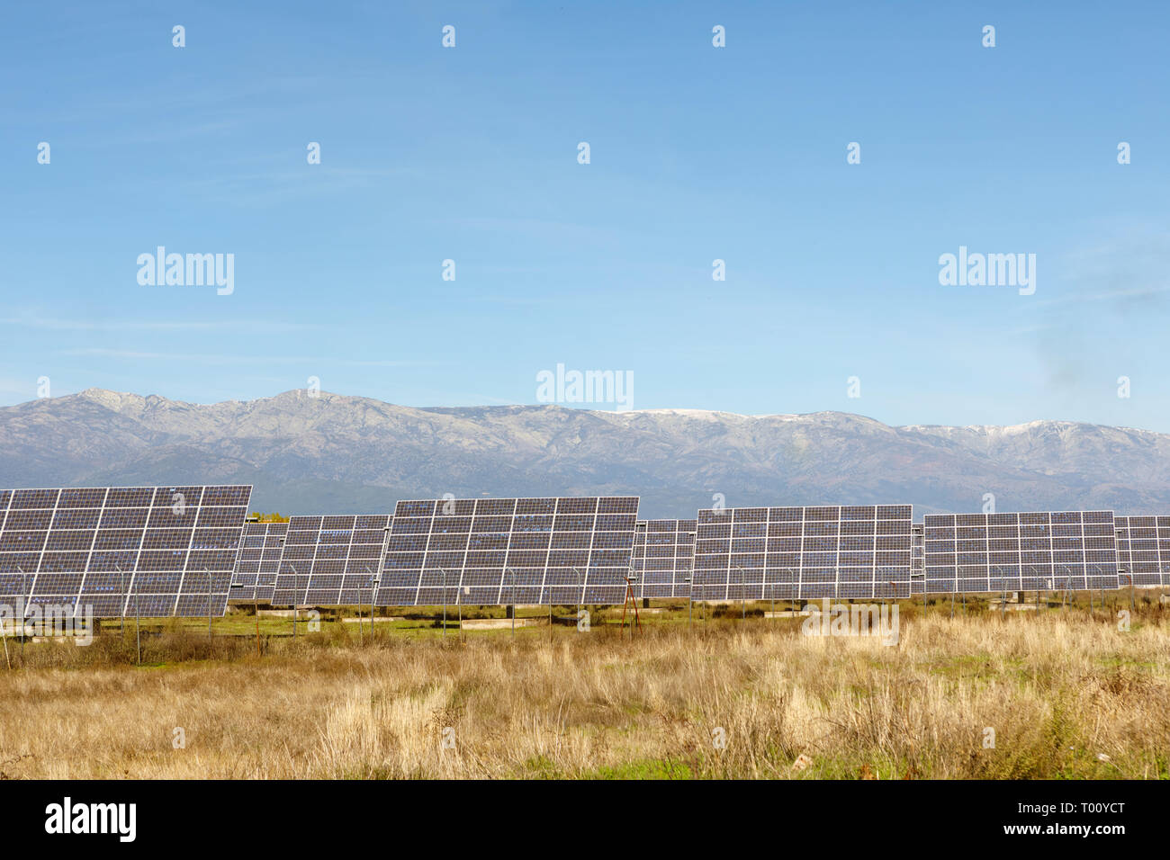 Energy plant with solar panels and a mountain of background Stock Photo ...