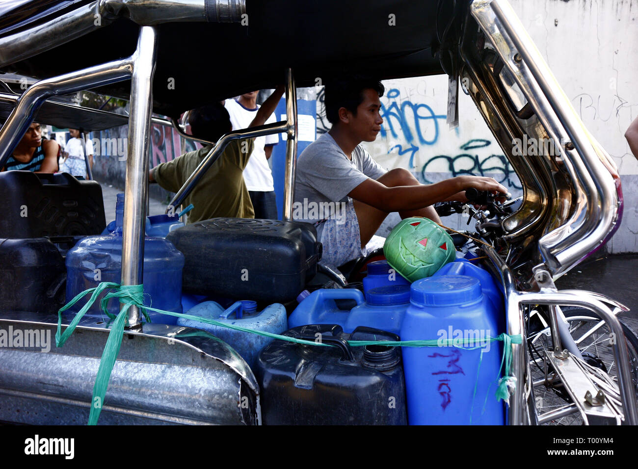ANTIPOLO CITY, PHILIPPINES - MARCH 14, 2019: Residents line up with ...