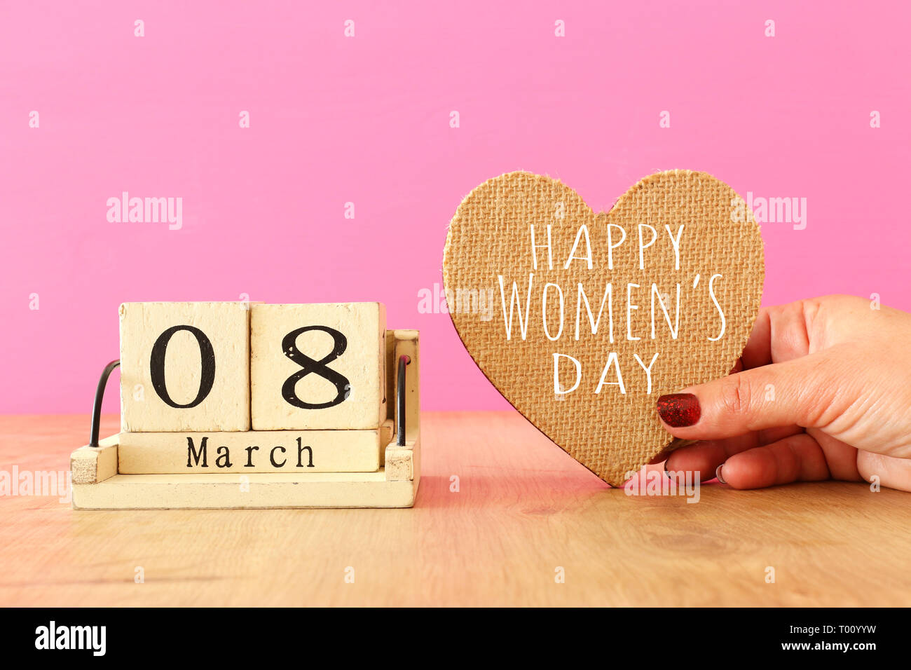 wooden March 8 calendar next to heart over pink wooden background Stock ...