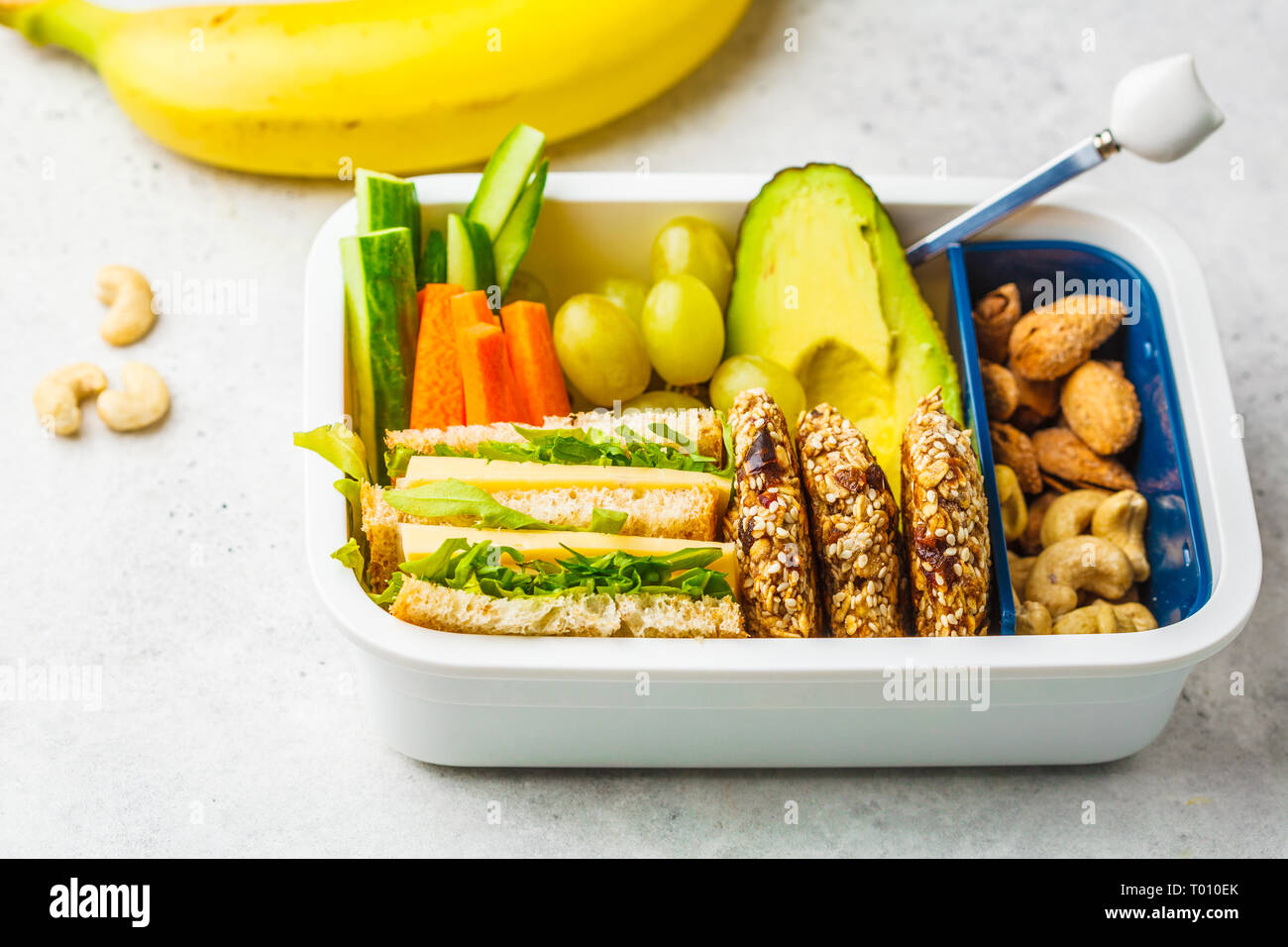 School healthy lunch box with sandwich, cookies, nuts, fruits and ...