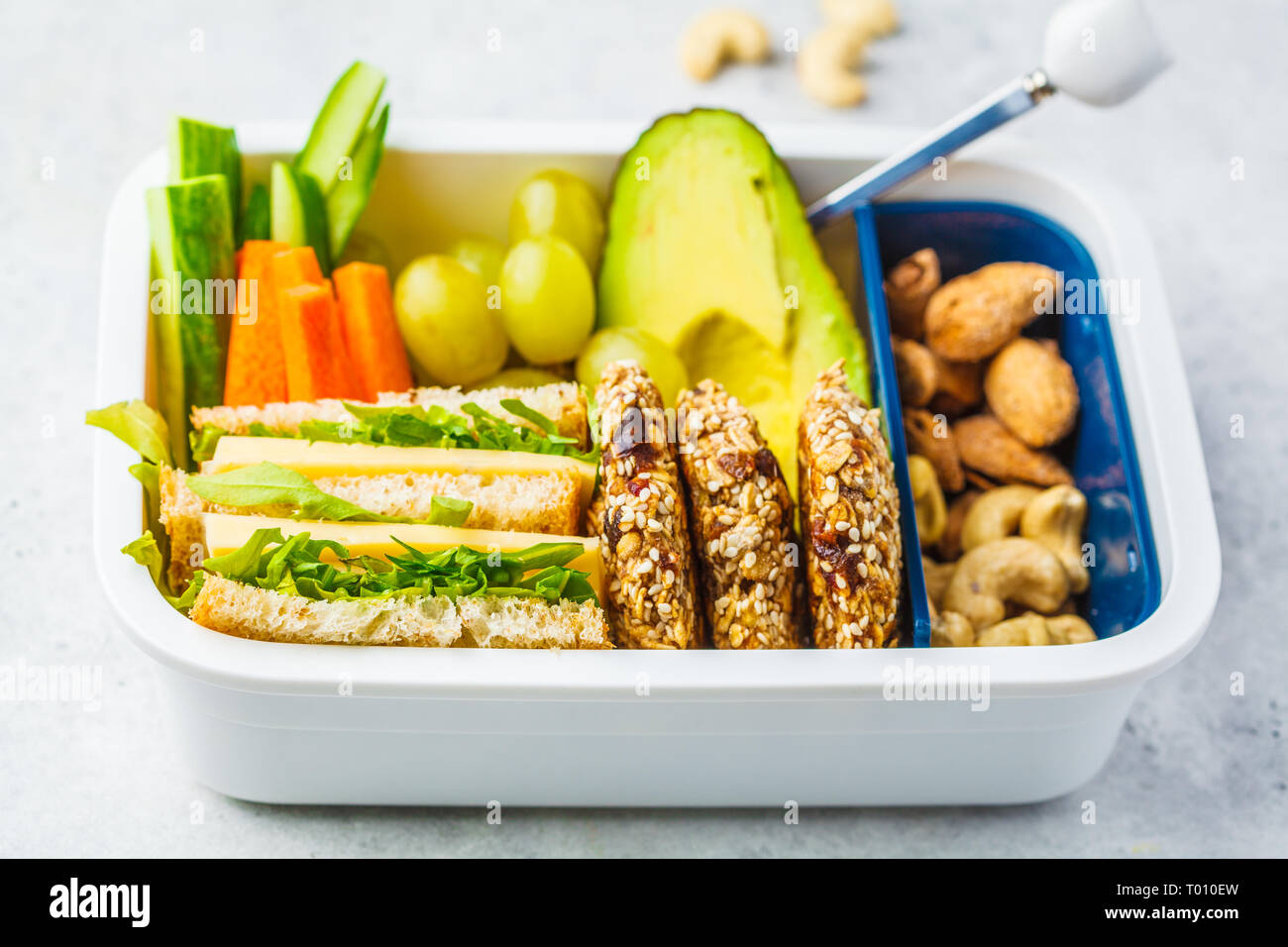 School healthy lunch box with sandwich, cookies, nuts, fruits and ...