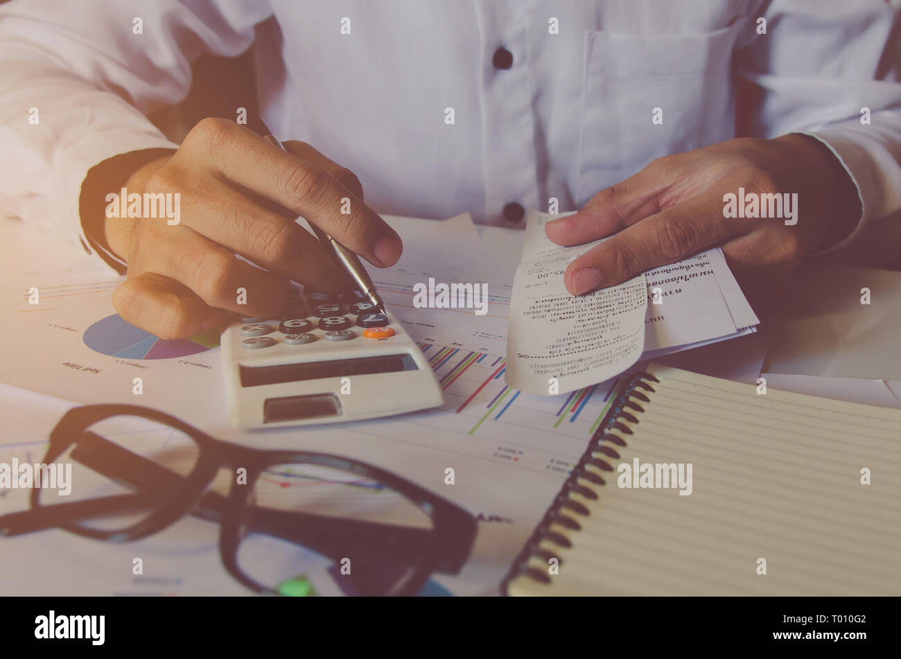 Man hand using calculator with calculate bills and Financial data ...