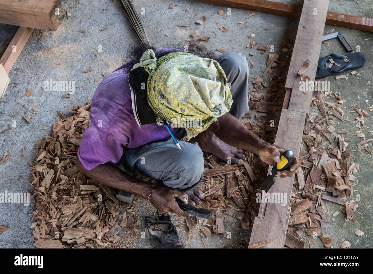Carpenter working in traditional manual carpentry shop in a third world ...