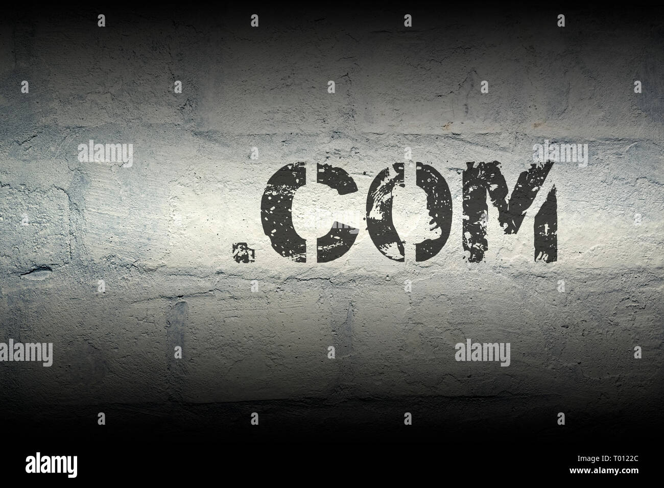dot com stencil print on the grunge white brick wall Stock Photo - Alamy