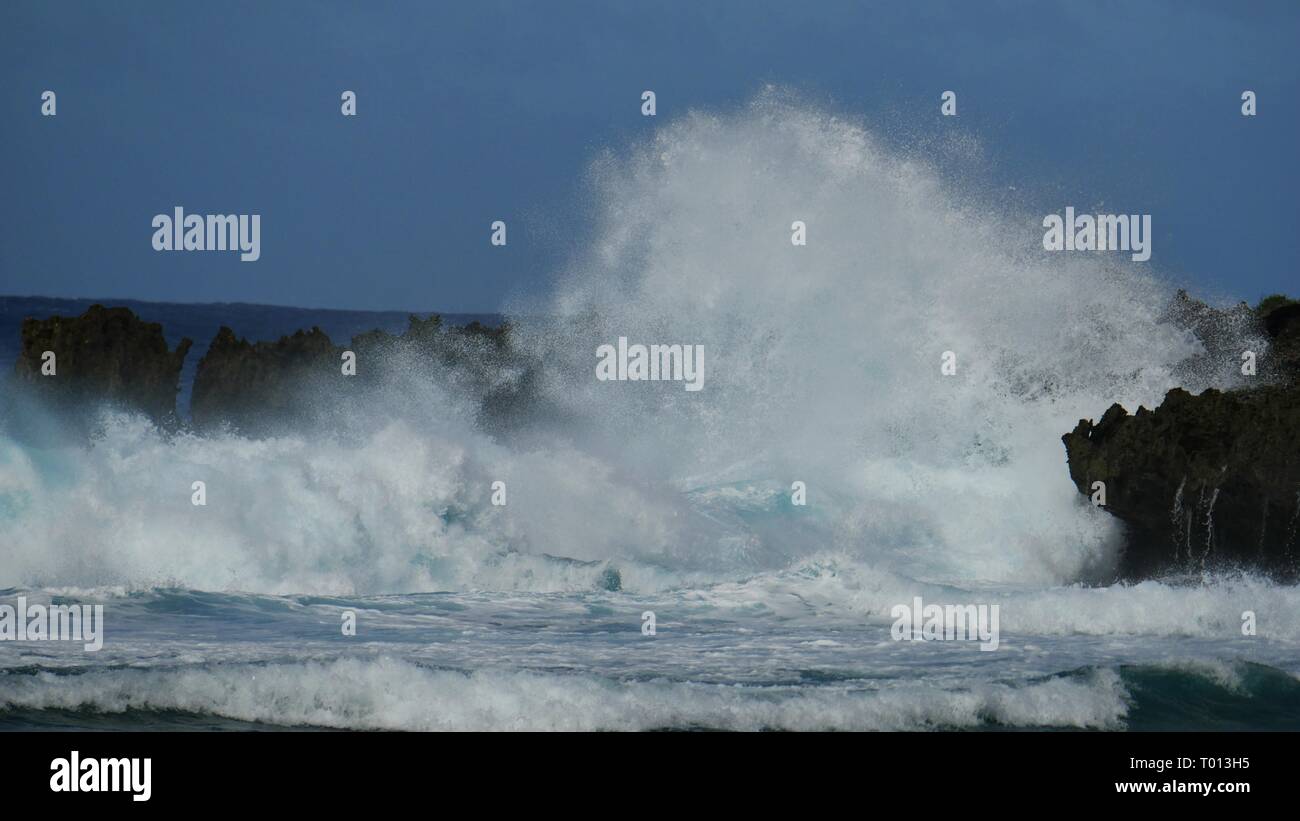 Huge angry waves foaming against sharp cliff lines create a ...