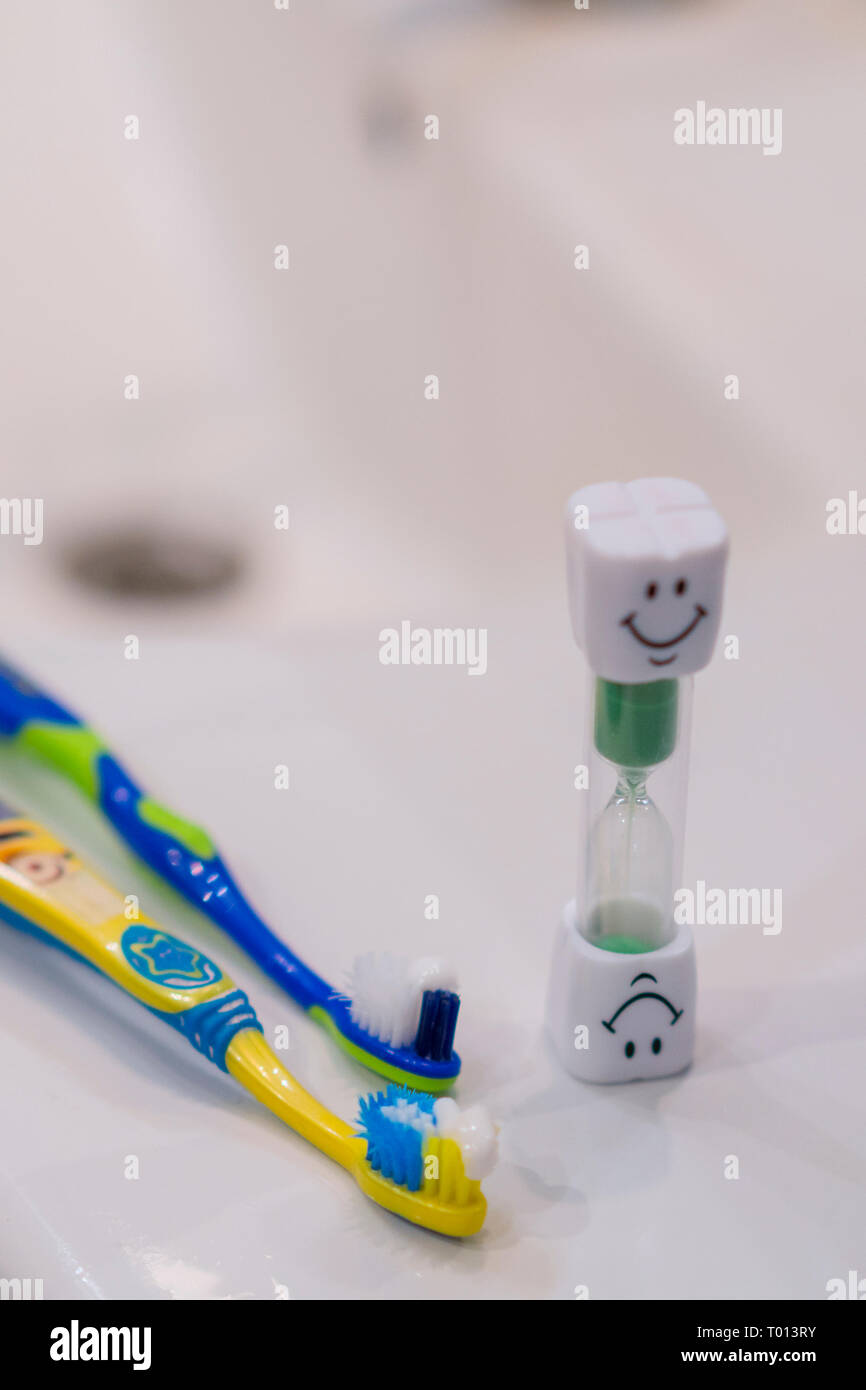 Concept of recommended time to brush your teeth. Soft focus. Two ...