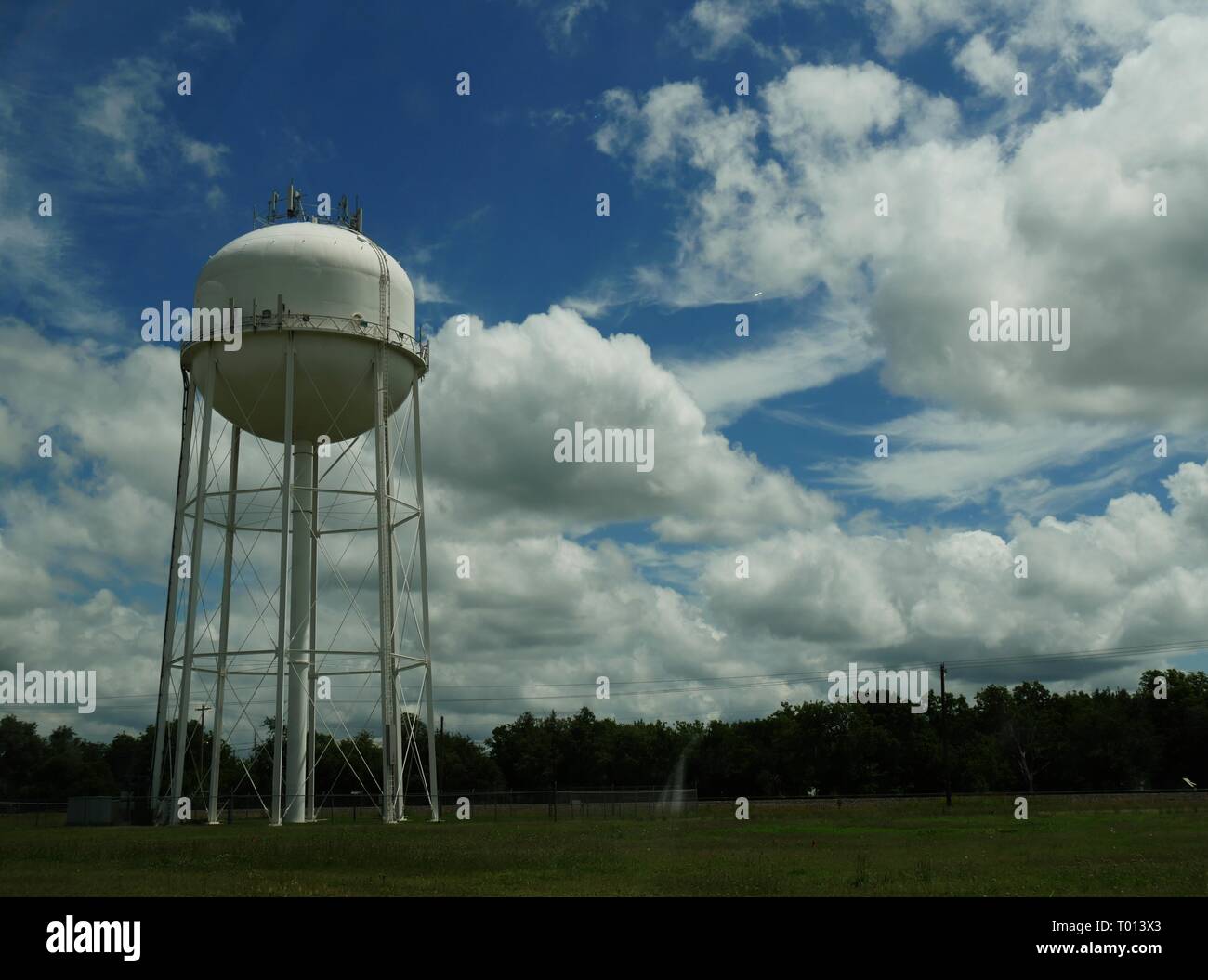 Huge water tank with backdrop of white fluffy clouds Stock Photo - Alamy