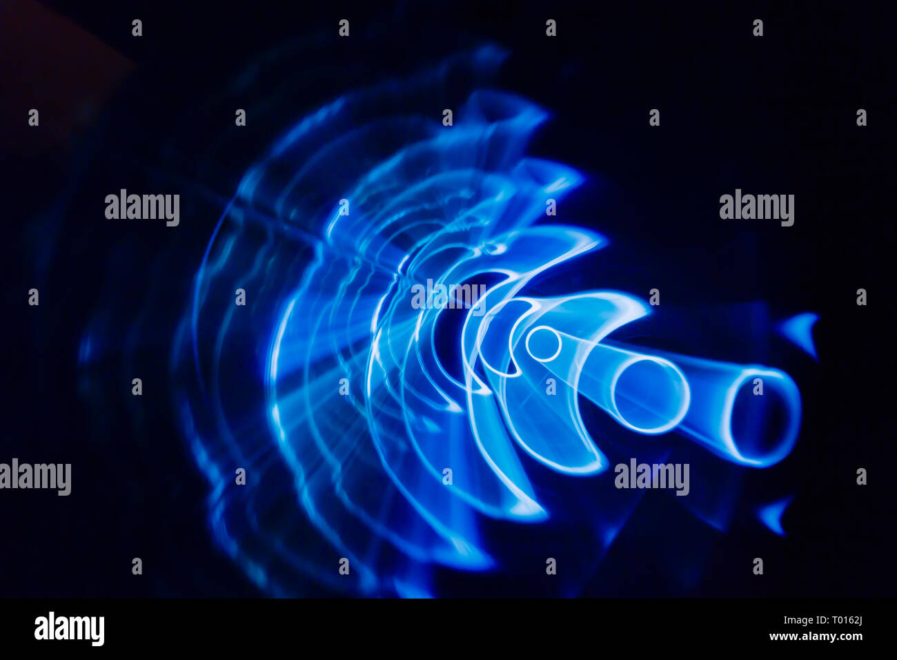 Sound waves in the visible blue color in the dark Stock Photo - Alamy