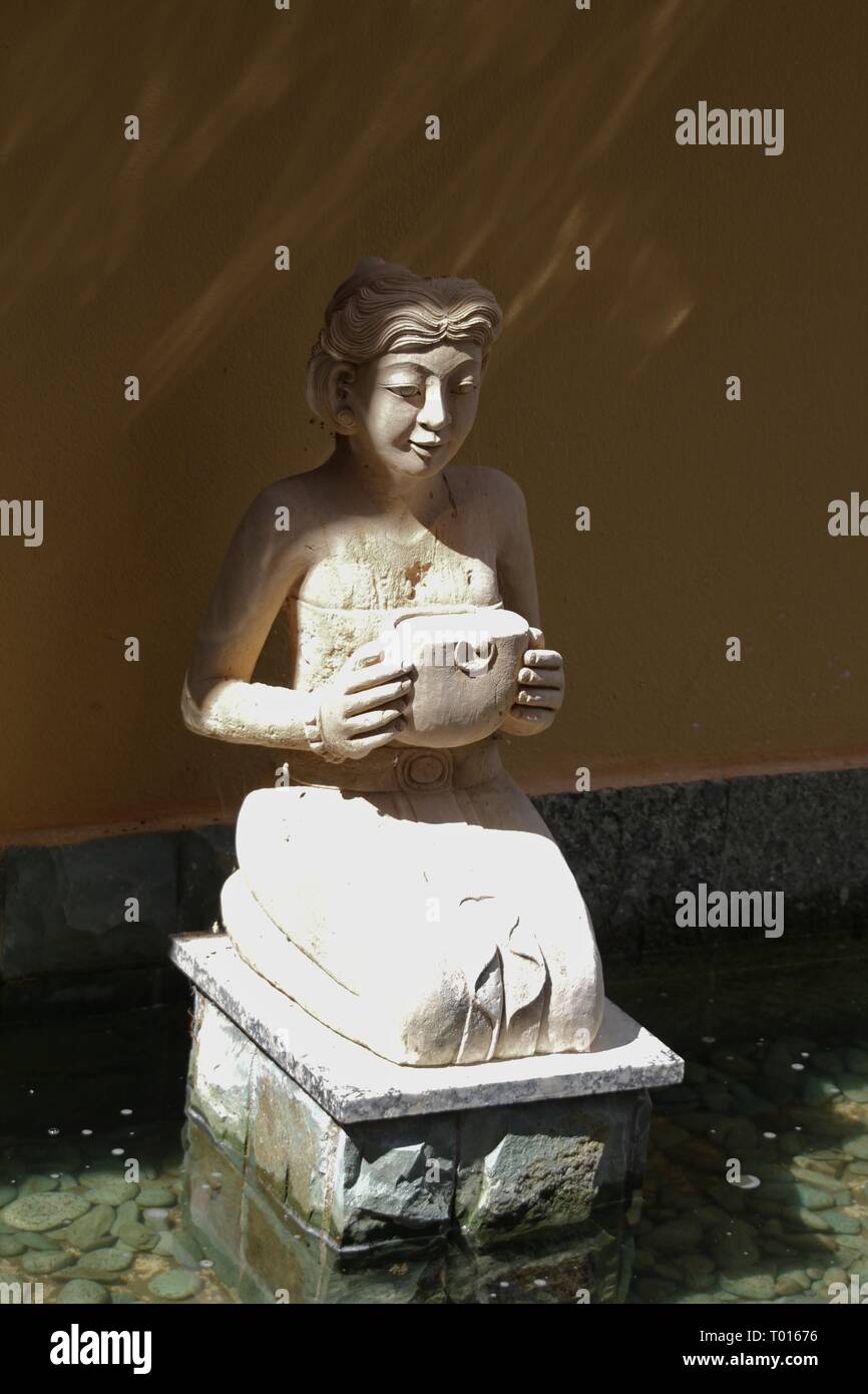 A cement female statue sitting, front view Stock Photo - Alamy