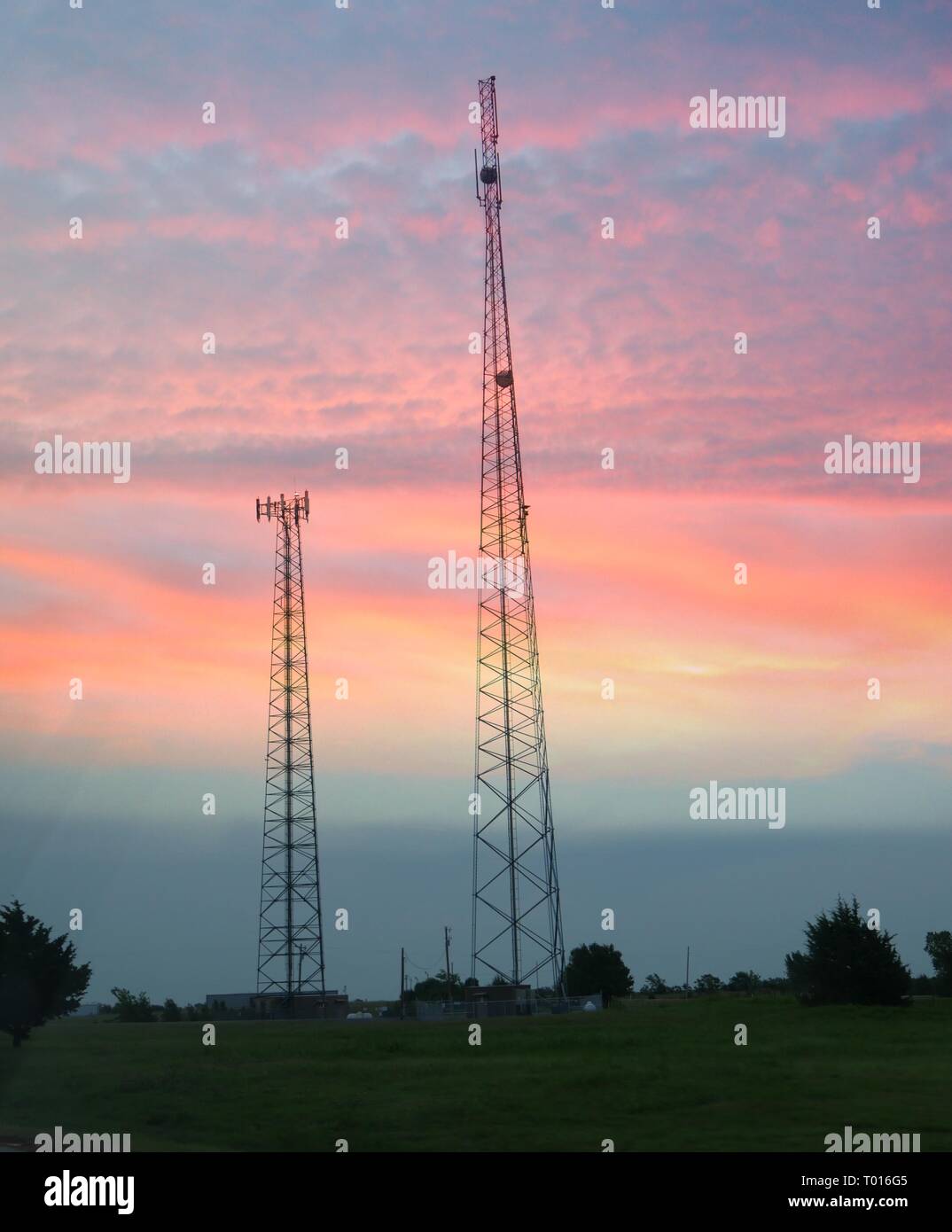 Electric power poles rising out at sunrise Stock Photo - Alamy