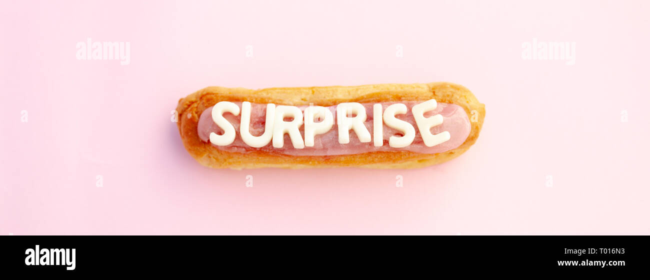Surprise word written in eclair voluminous white letters on a beautiful ...
