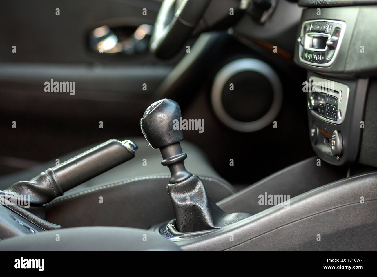 Luxurious car black leather interior. Close-up detail of handbrake ...