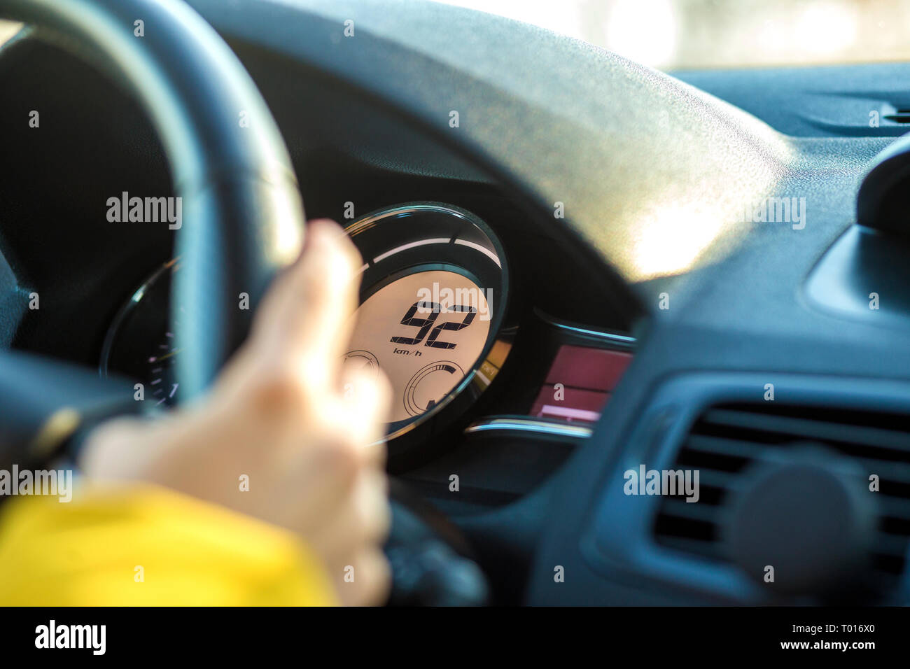 Modern car interior with driver hand on steering wheel. Safe driving ...
