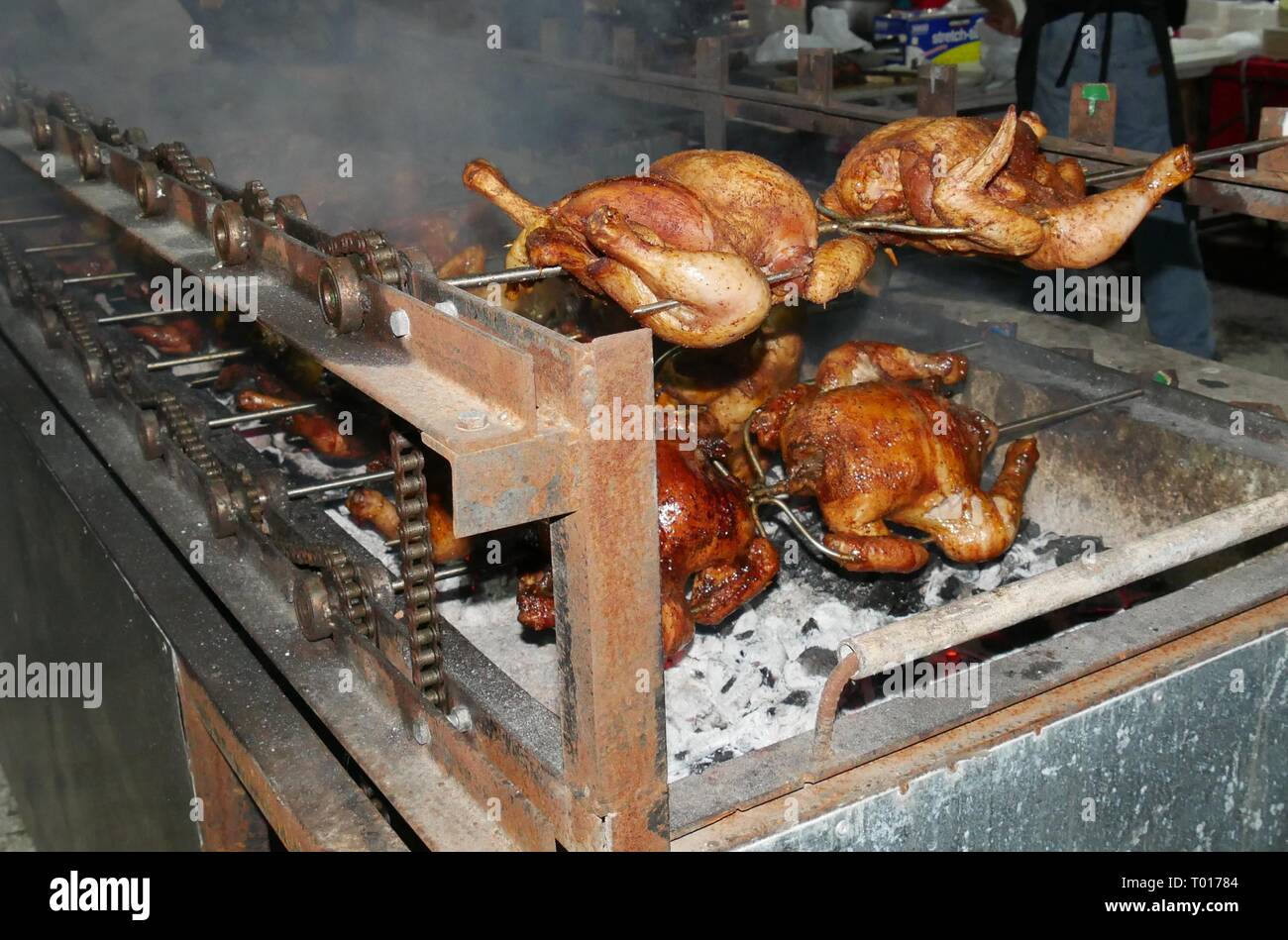 Roasting chicken over live coals is very popular in the Philippines and ...