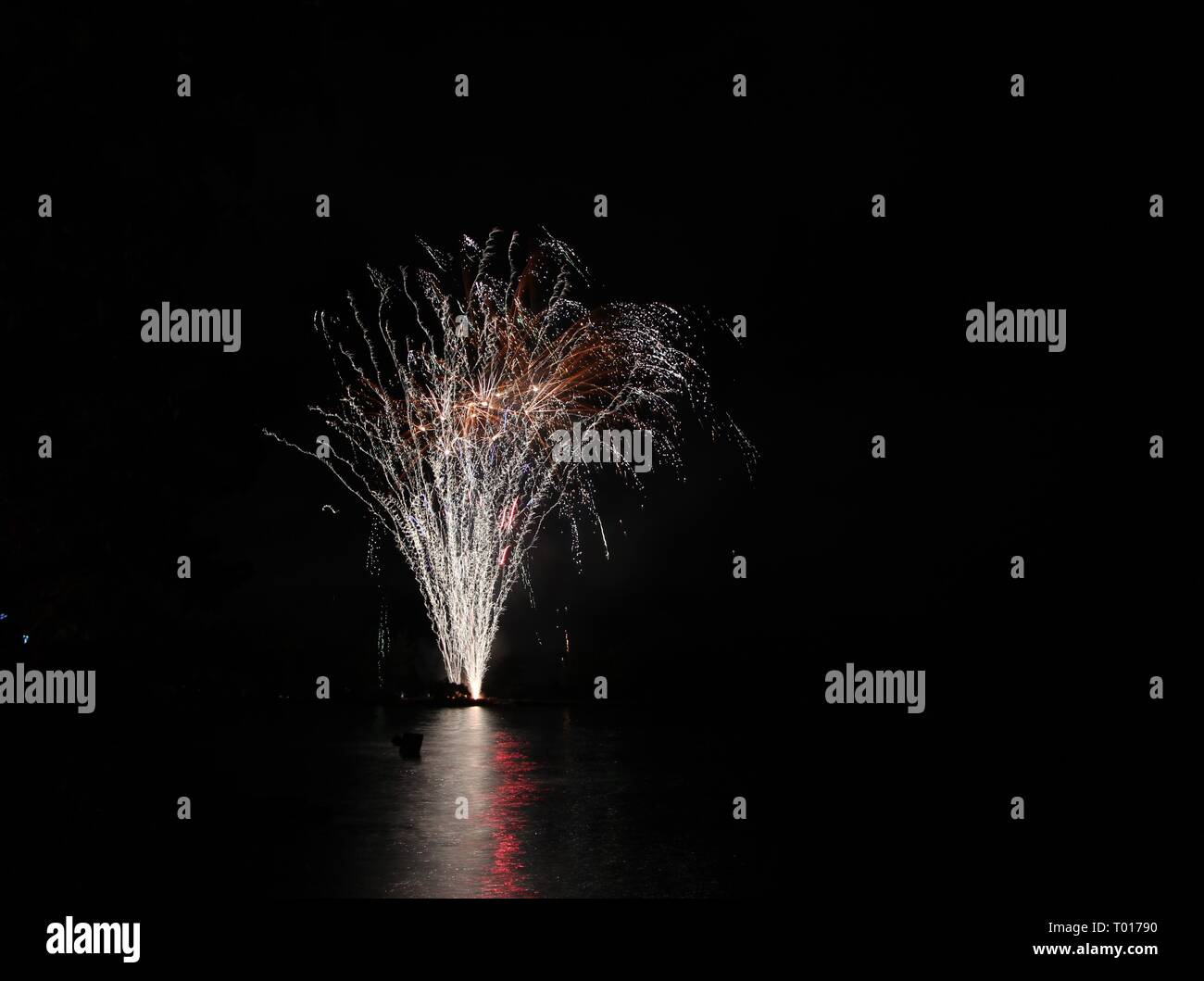 Burst of firework showers in a dark sky background Stock Photo - Alamy