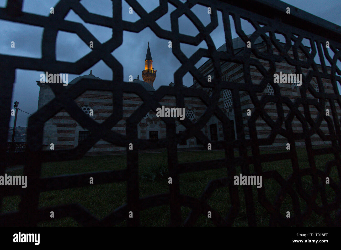 A mosque and its sodium lamp illuminated minaret seen from a forged ...