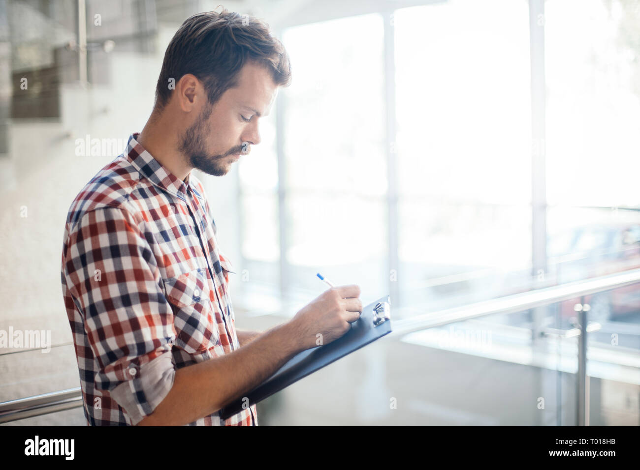 Casual worker with checklist Stock Photo - Alamy