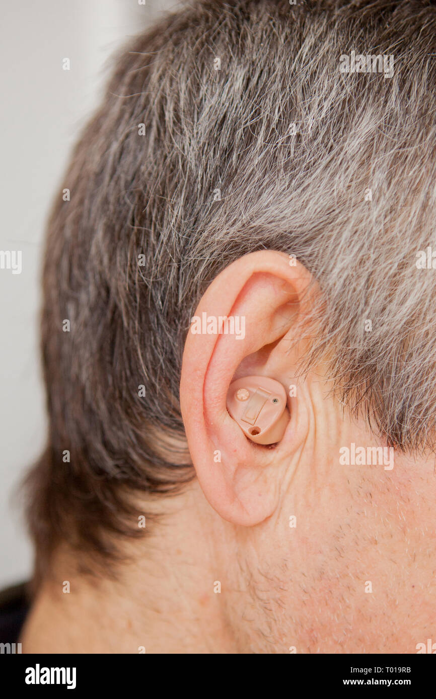 Close-up Digital modern hearing aid in the ear of aged old man Stock ...