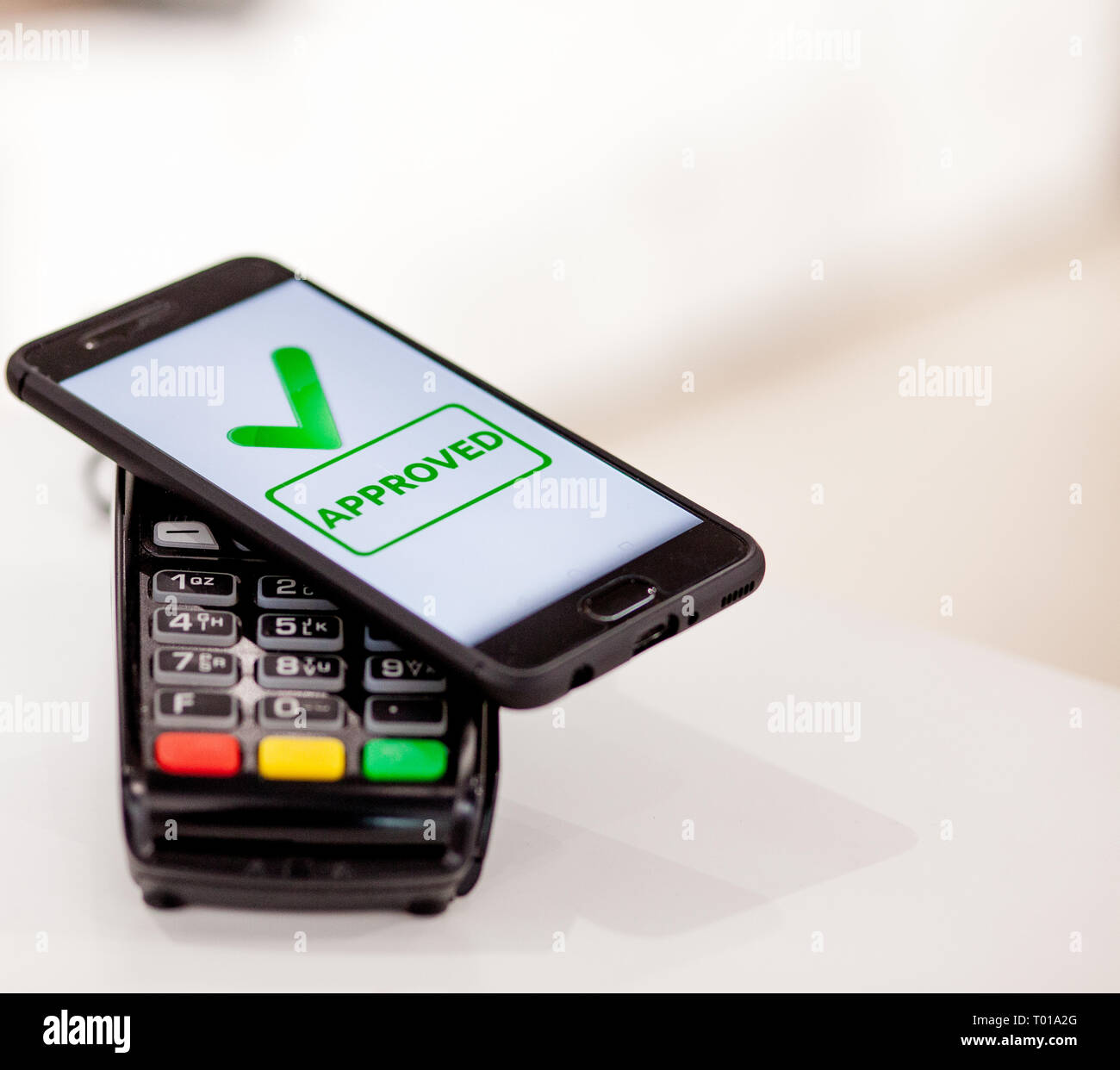 POS terminal, Payment Machine with mobile phone on store background ...