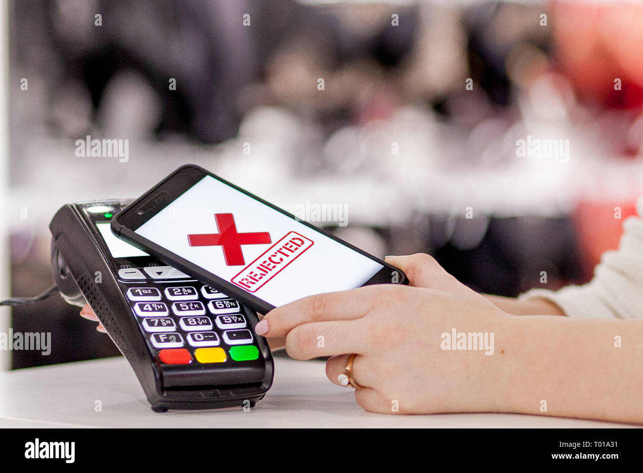 POS terminal, Payment Machine with mobile phone on store background ...