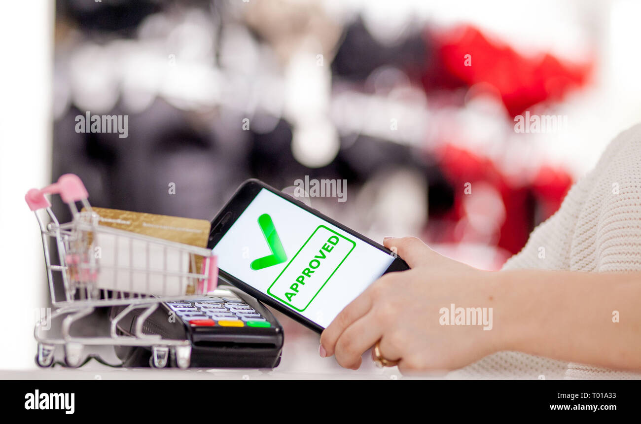 POS terminal, Payment Machine with mobile phone on store background ...