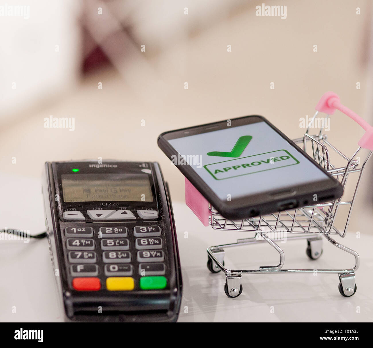 POS terminal, Payment Machine with mobile phone on store background ...