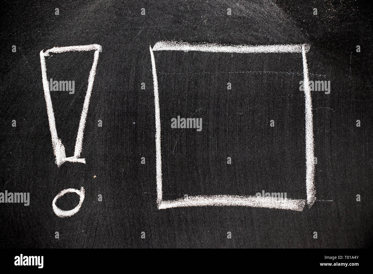 White color chalk hand drawing in exclamation mark with blank square ...