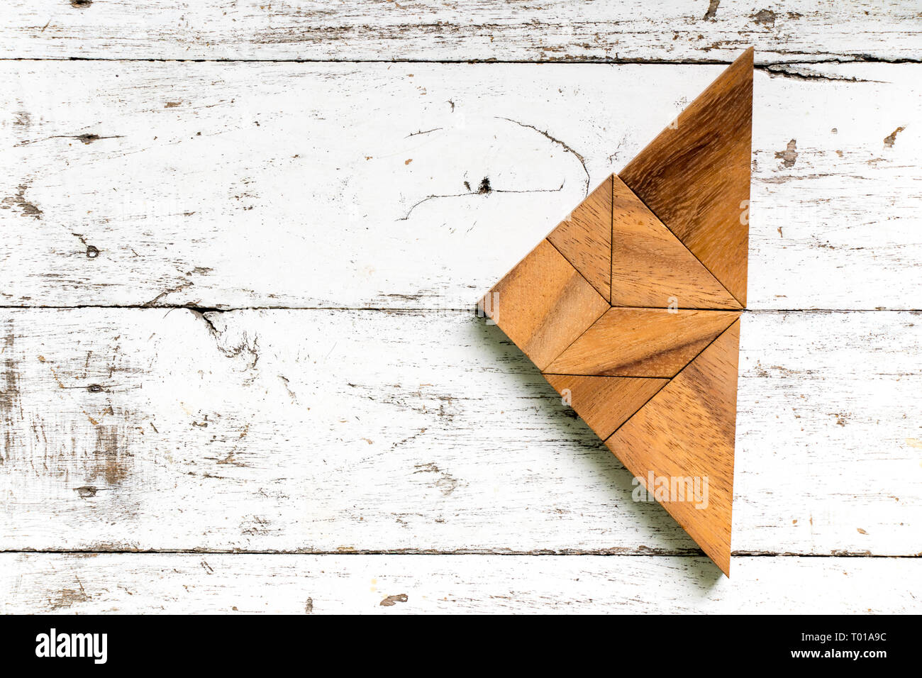 Tangram puzzle in triangle shape on old white wood background Stock ...