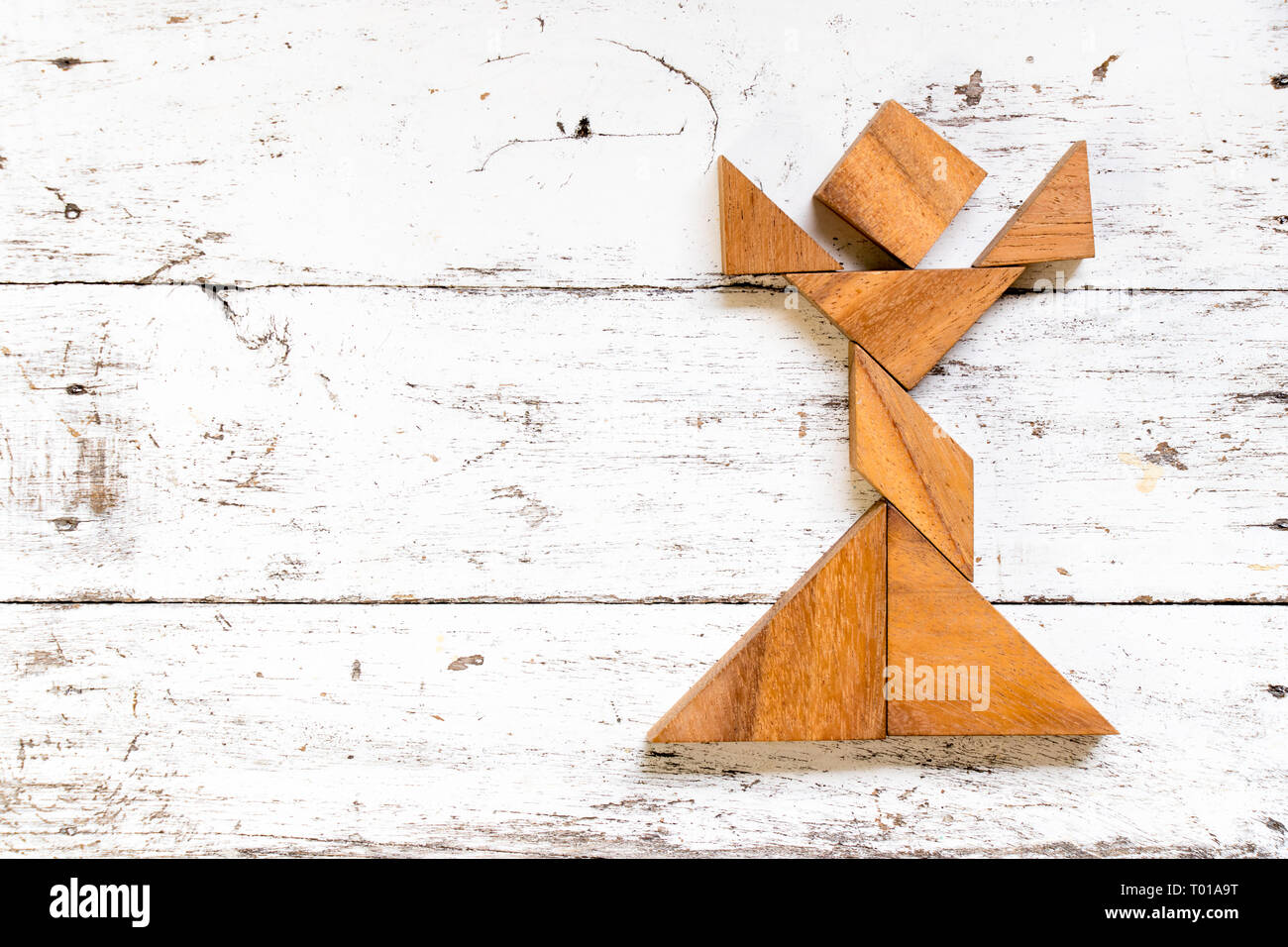 Tangram puzzle in singing girl shape on old white wood background Stock ...