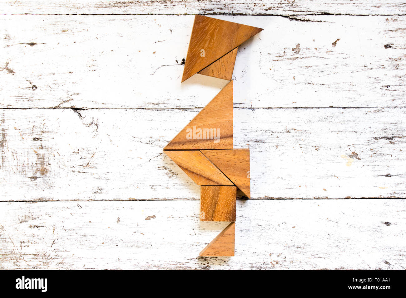 Tangram puzzle in man wear the hat shape on old white wood background ...