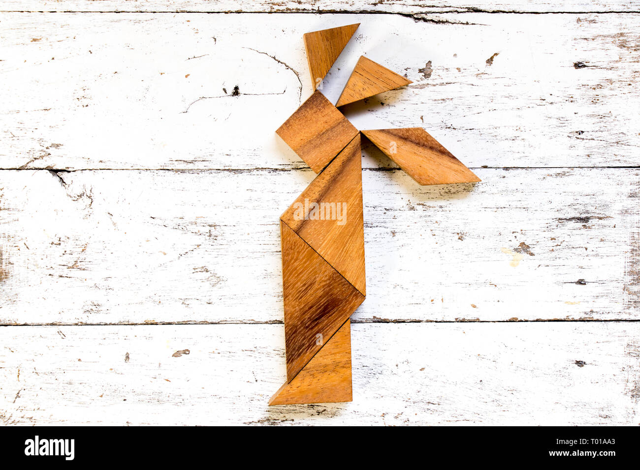 Tangram puzzle in native american indian shape on old white wood ...