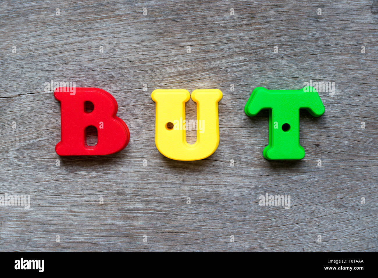 Colorful plastic alphabet in word but on wood background Stock Photo ...