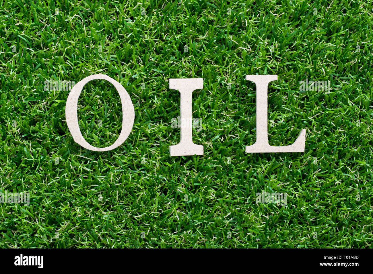 Wood alphabet in word oil on artificial green grass background Stock ...
