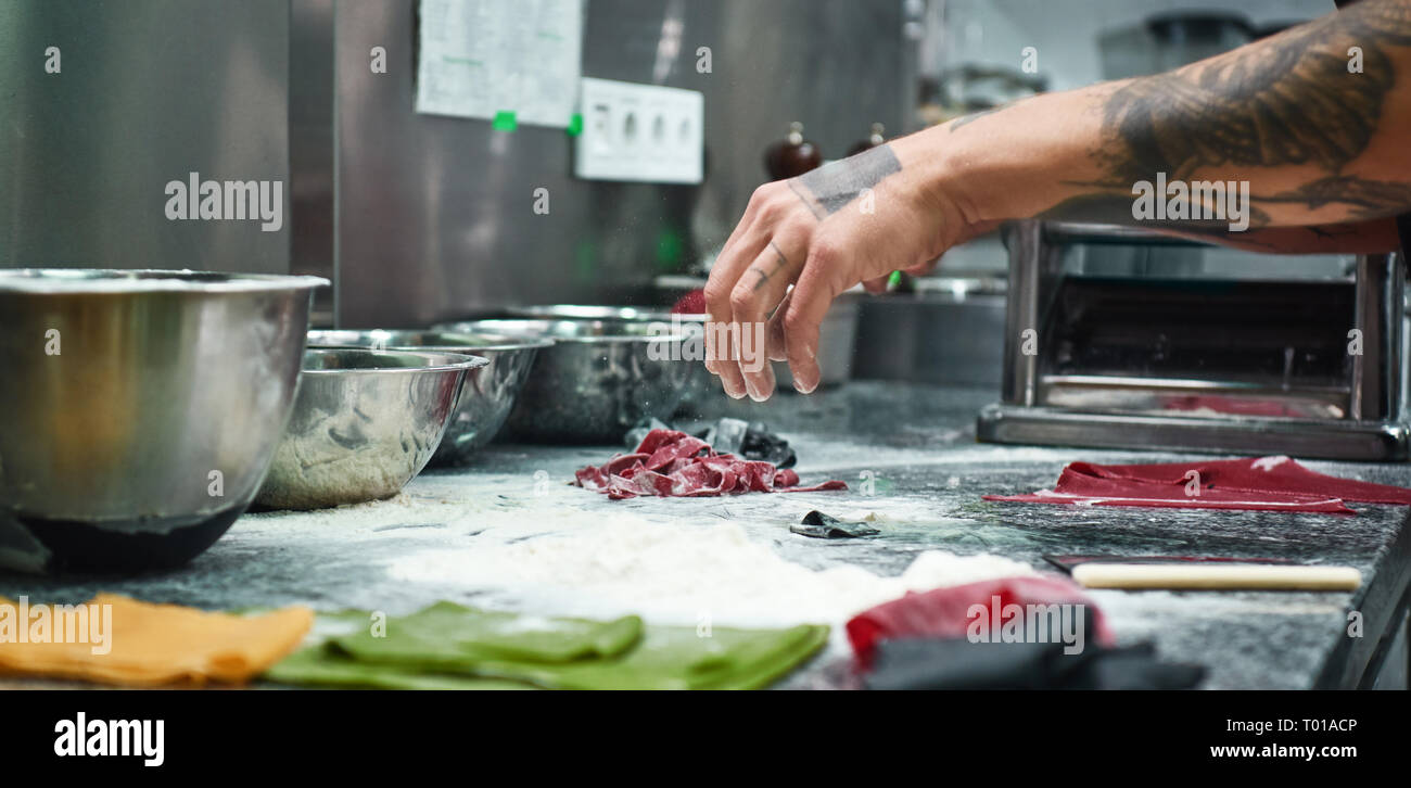 Cooking moments. Cropped image of chef's hands with beautiful tattoos ...