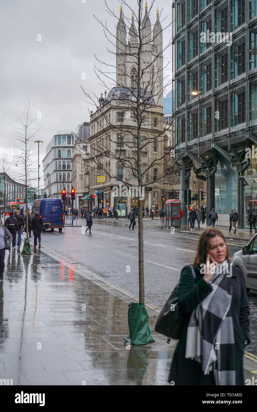 rainy day street scene in London with pedestrians, historic ...