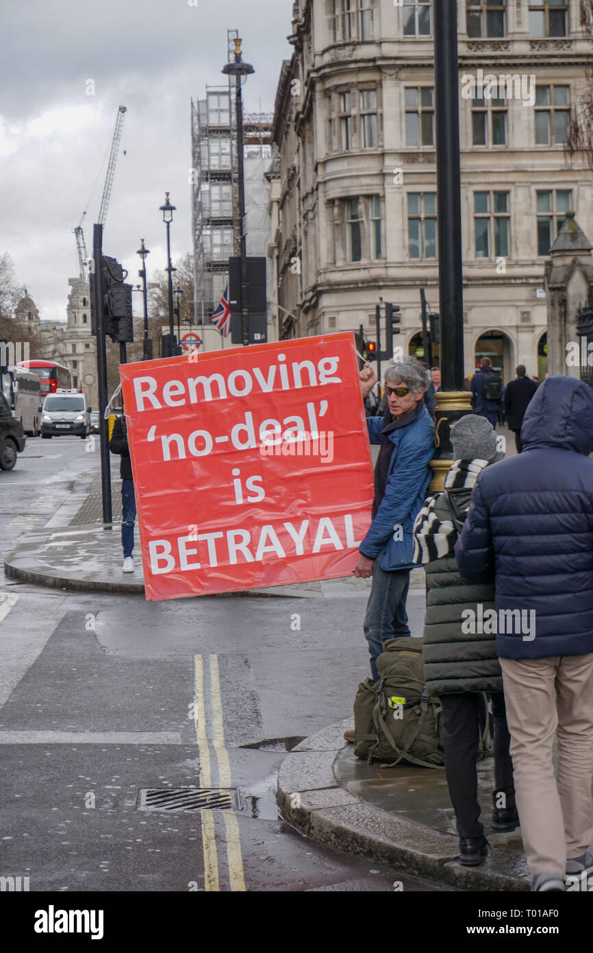 Brexit protest with demonstrators holding red signs near Parliament ...