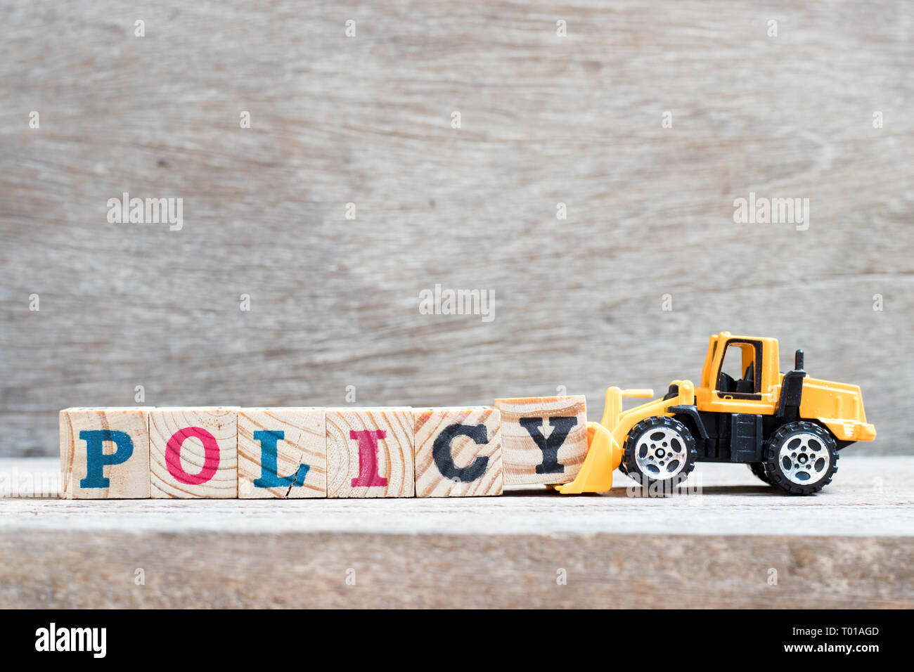 Toy bulldozer hold letter block y to complete word policy on wood ... Toy bulldozer hold letter block y to complete word policy on wood ...