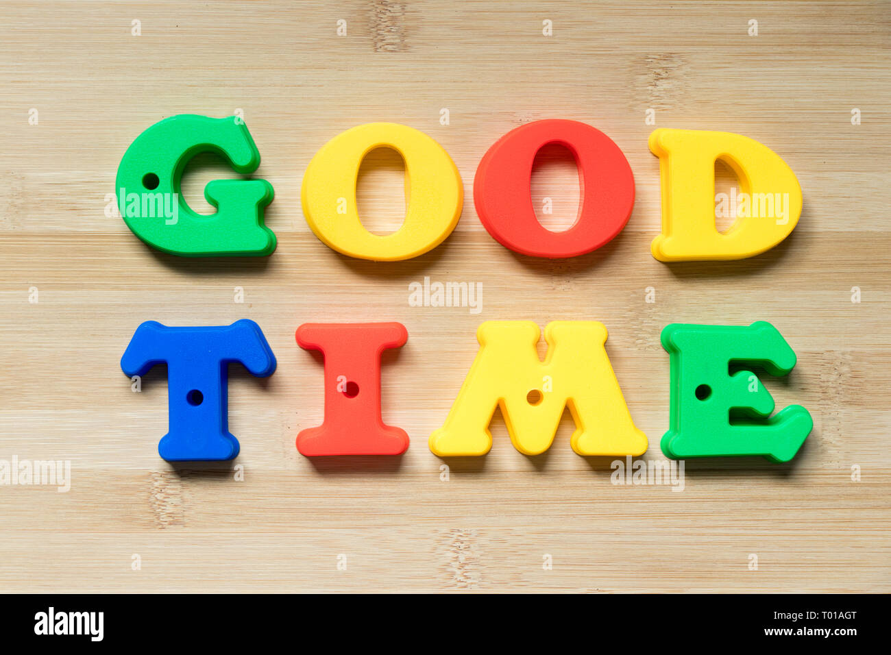 Color plastic alphabet in word good time on wood background Stock Photo ...