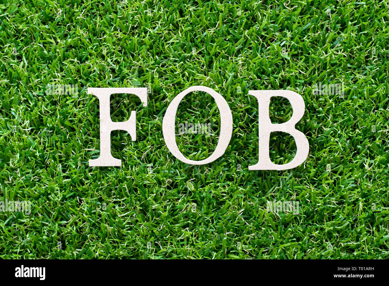Wood letter in word FOB (Abbreviation of free on board) on artificial ...