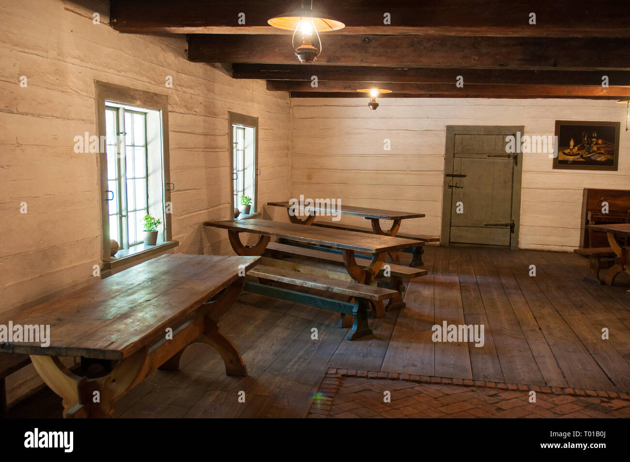 Antique interior. Ancient wooden old house. Tables and wooden benches ...