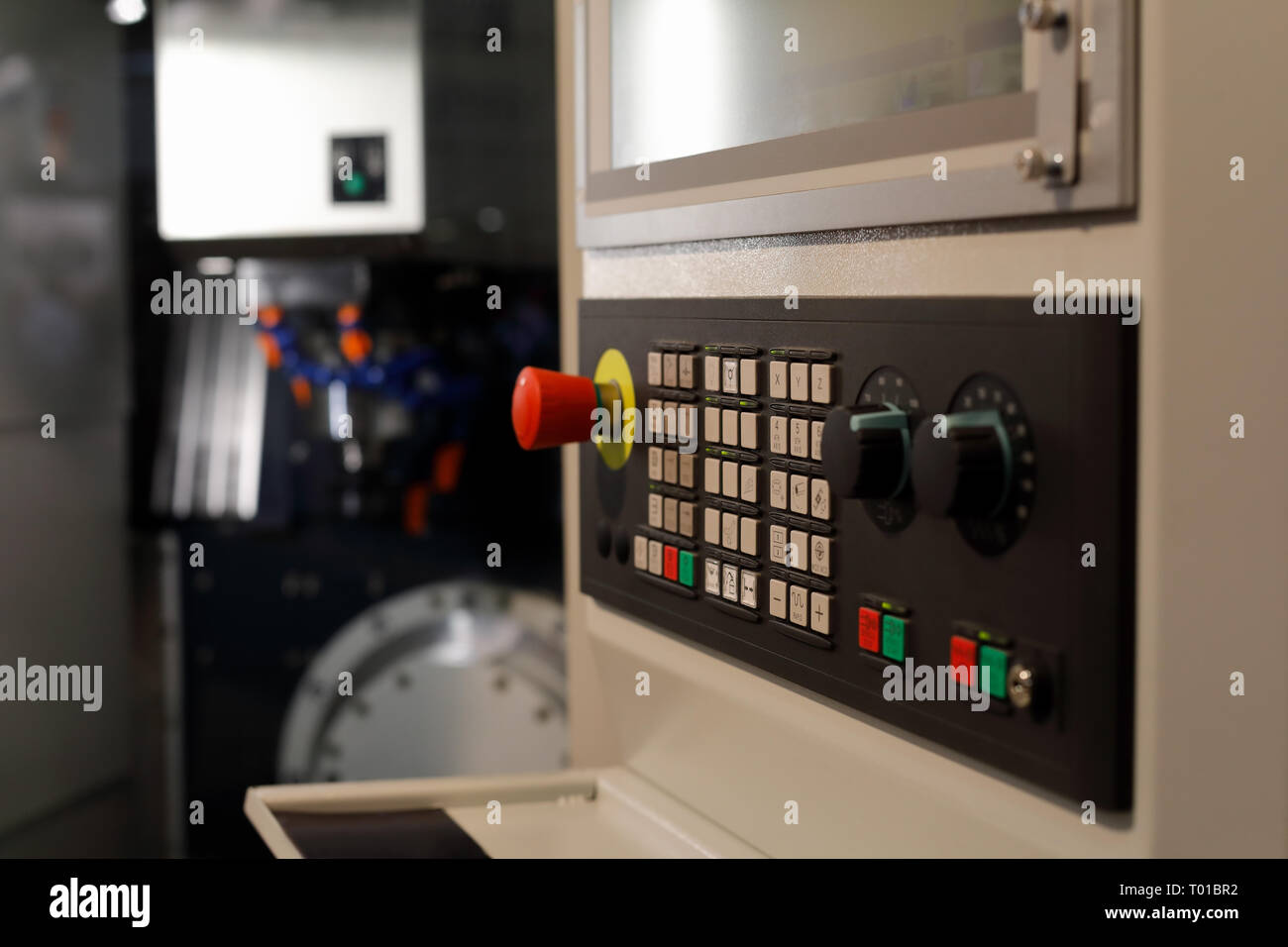 CNC machining center with a control panel in the foreground. Selective ...